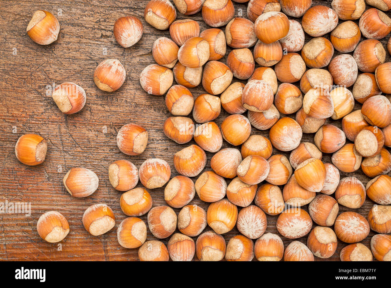 hazelnuts in shells over grunge weathered wood surface Stock Photo - Alamy