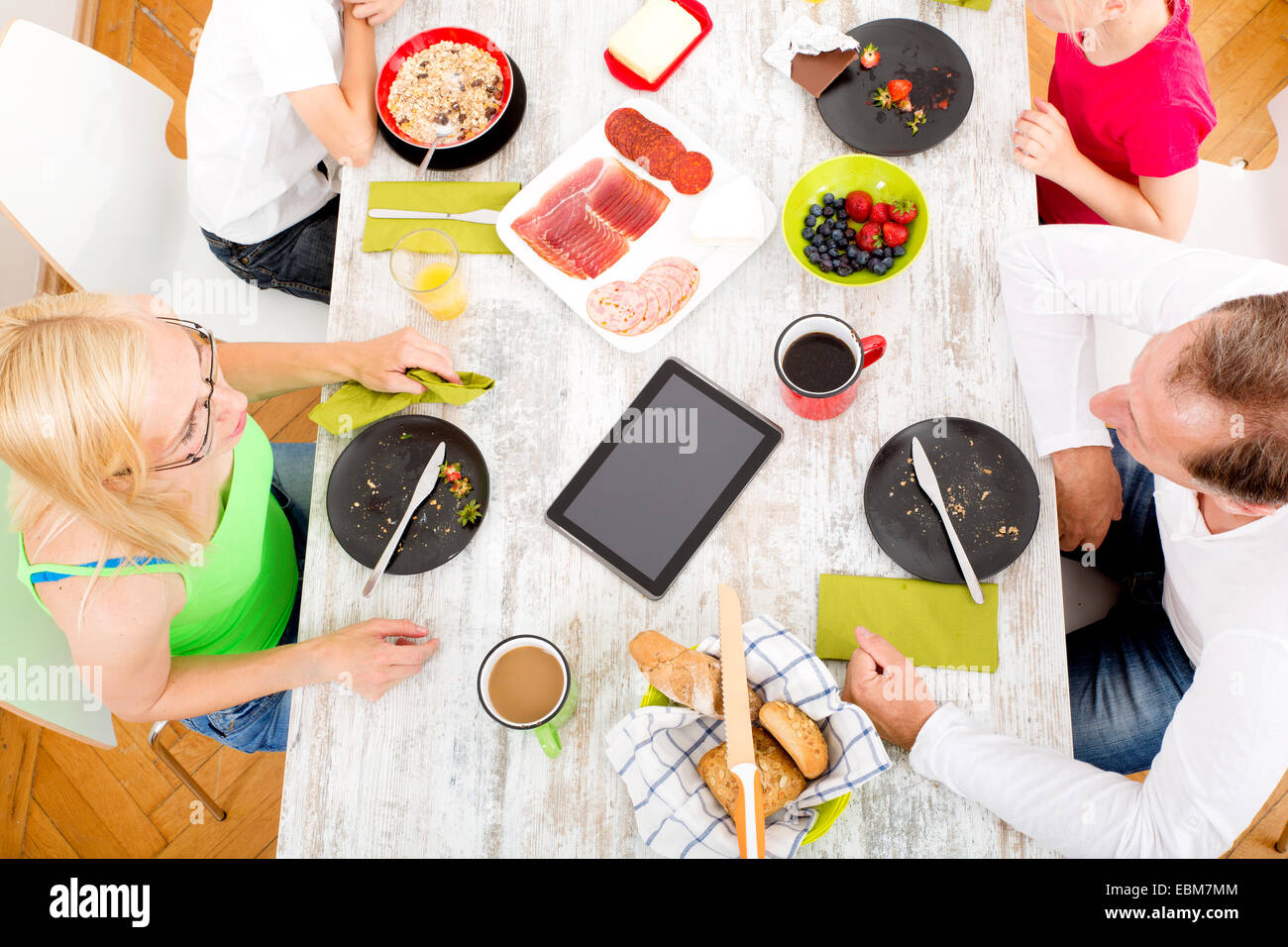 A family having breakfast at home seen from above with tablet Stock ...