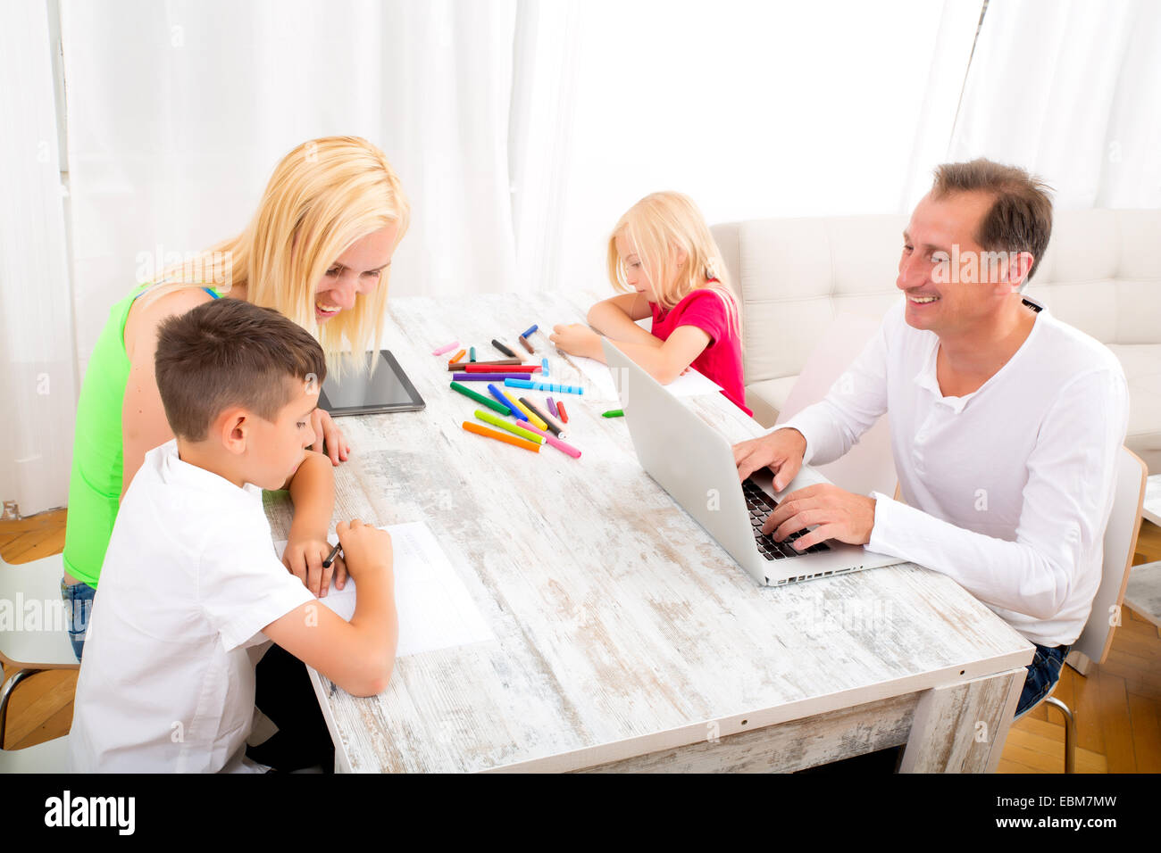 A family performing various activities at home Stock Photo - Alamy