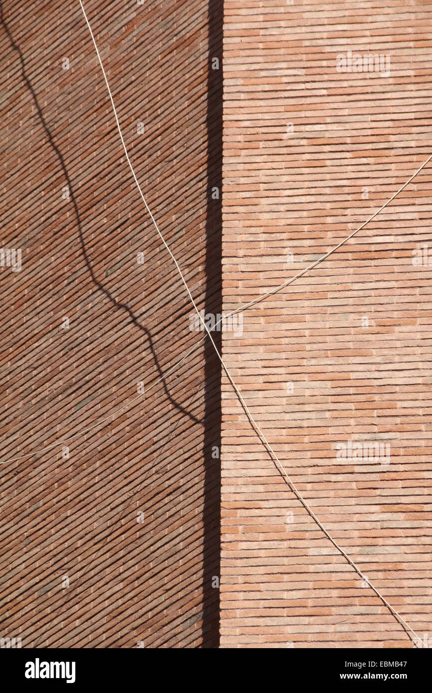 cables hanging from brick wall building property in city town Stock ...