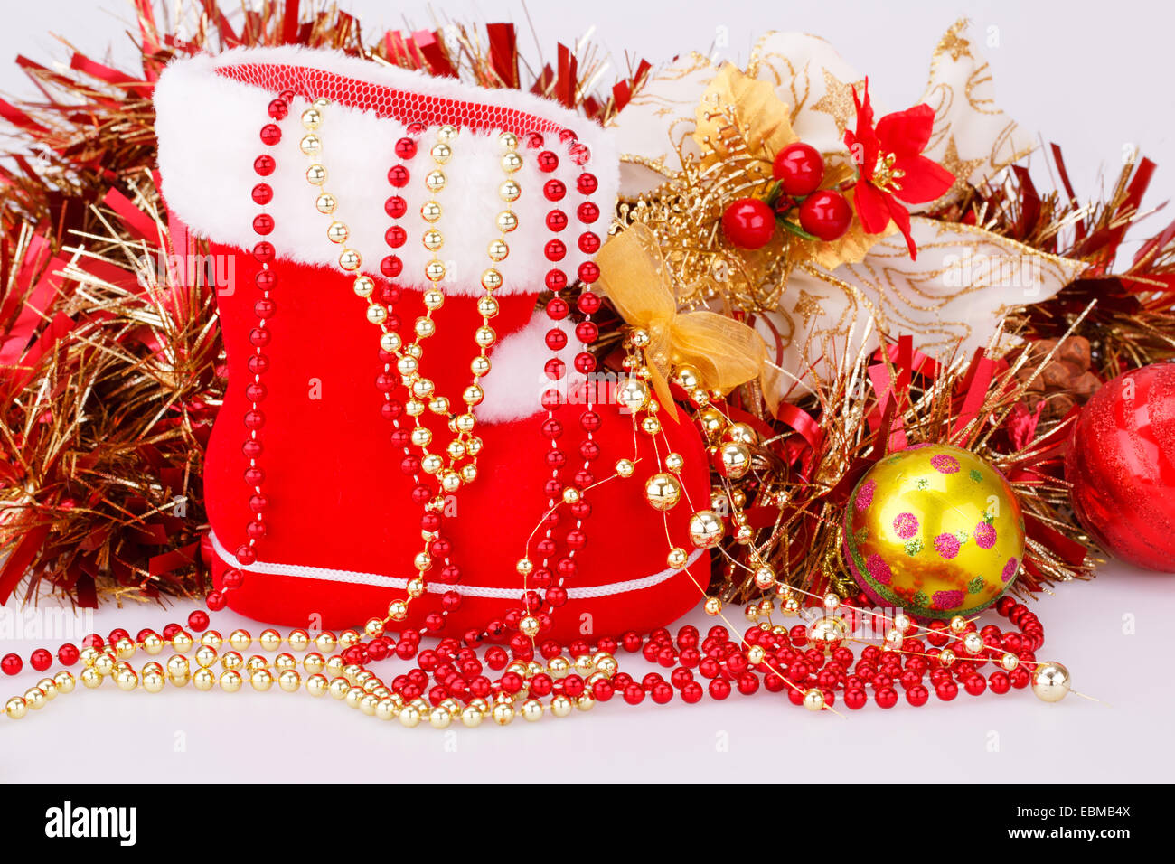 Christmas decoration with Santa's red boot, garland, beads closeup ...