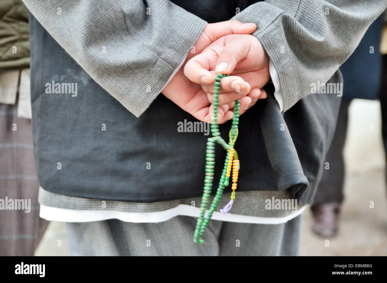 Man holding prayer beads, residence of Shaikh Nazim Al-Haqqani, leader ...