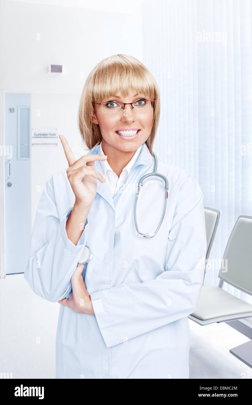 Portrait of nice doctor on color back Stock Photo - Alamy