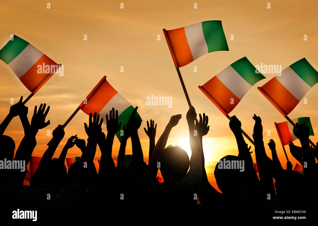Silhouettes of People Holding Flag of Ireland Stock Photo - Alamy