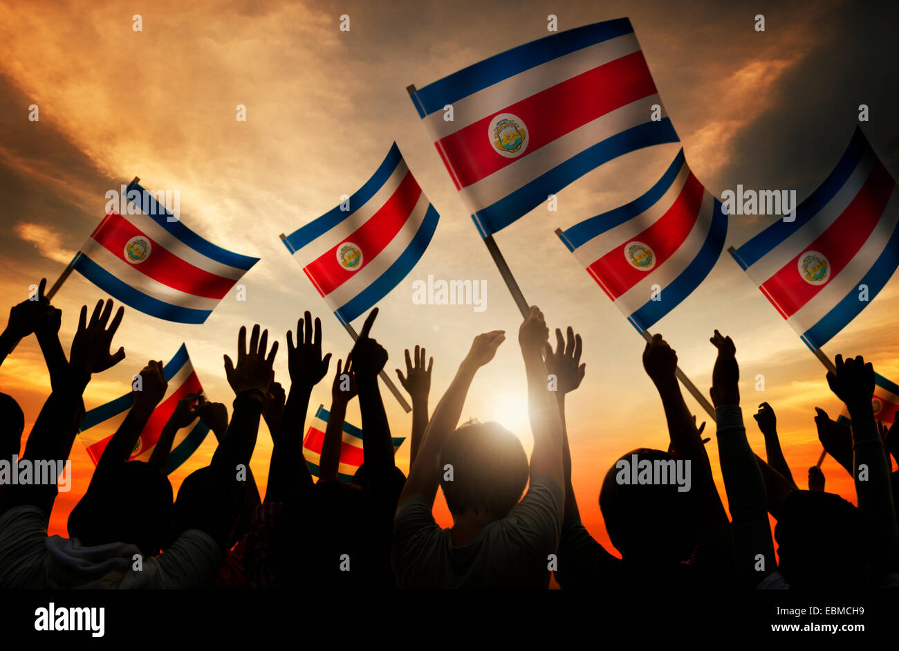Silhouettes of People Holding Flag of Costa Rica Stock Photo - Alamy