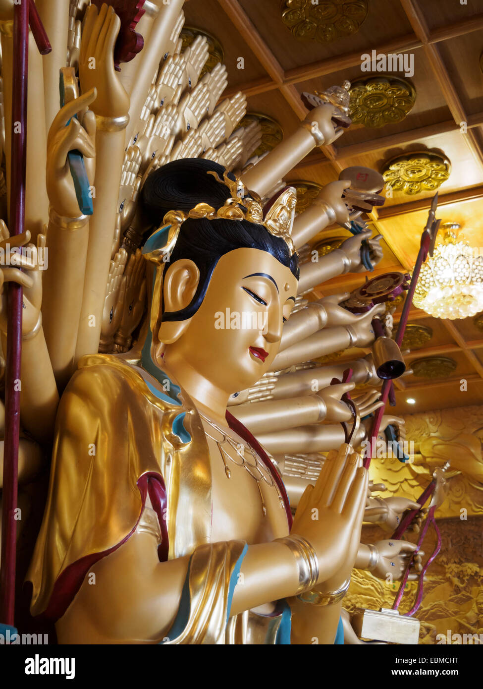 Golden bodhisattva with multiple arms at the Avalokiteshvara Hall of ...