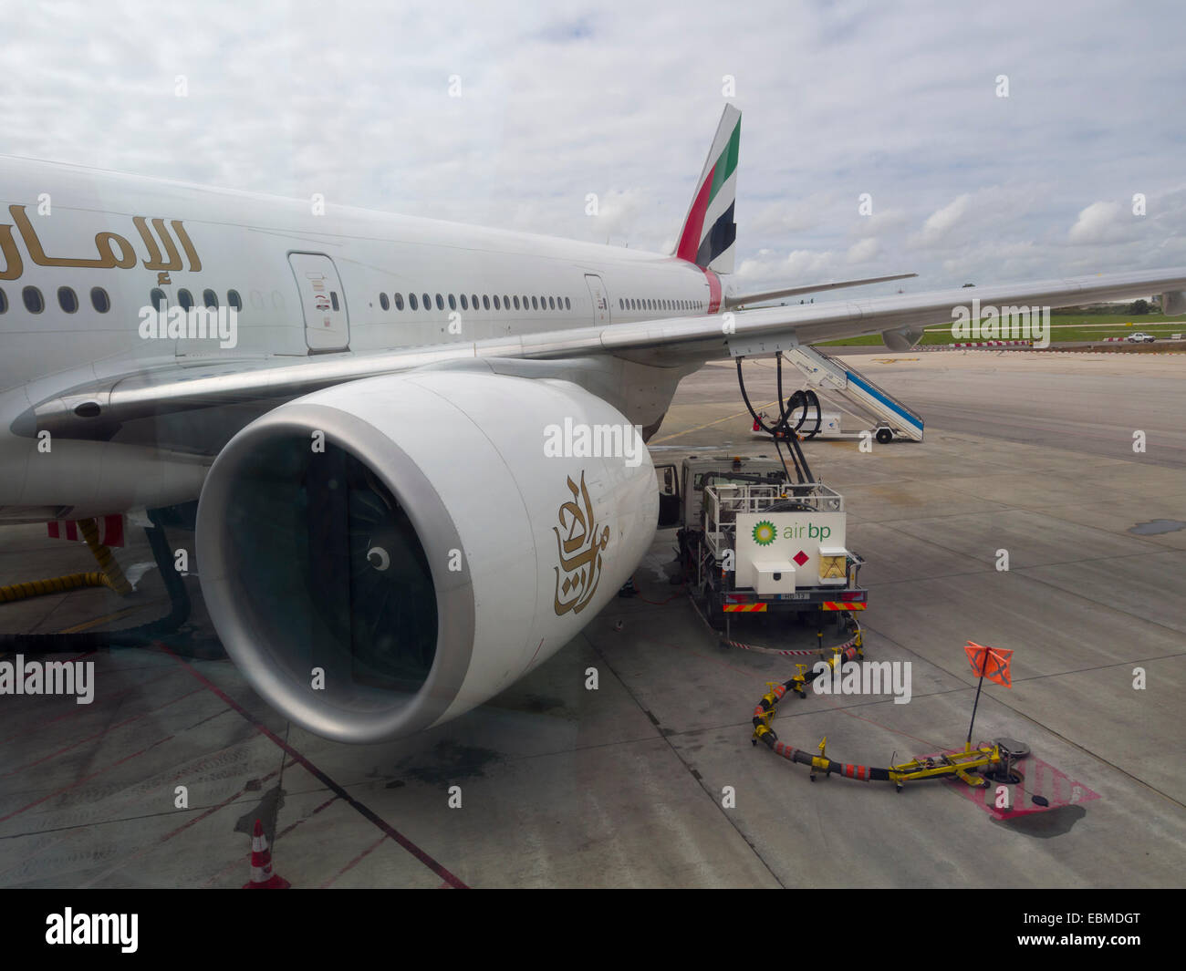Emirates airplane refueling at airport runway Stock Photo - Alamy