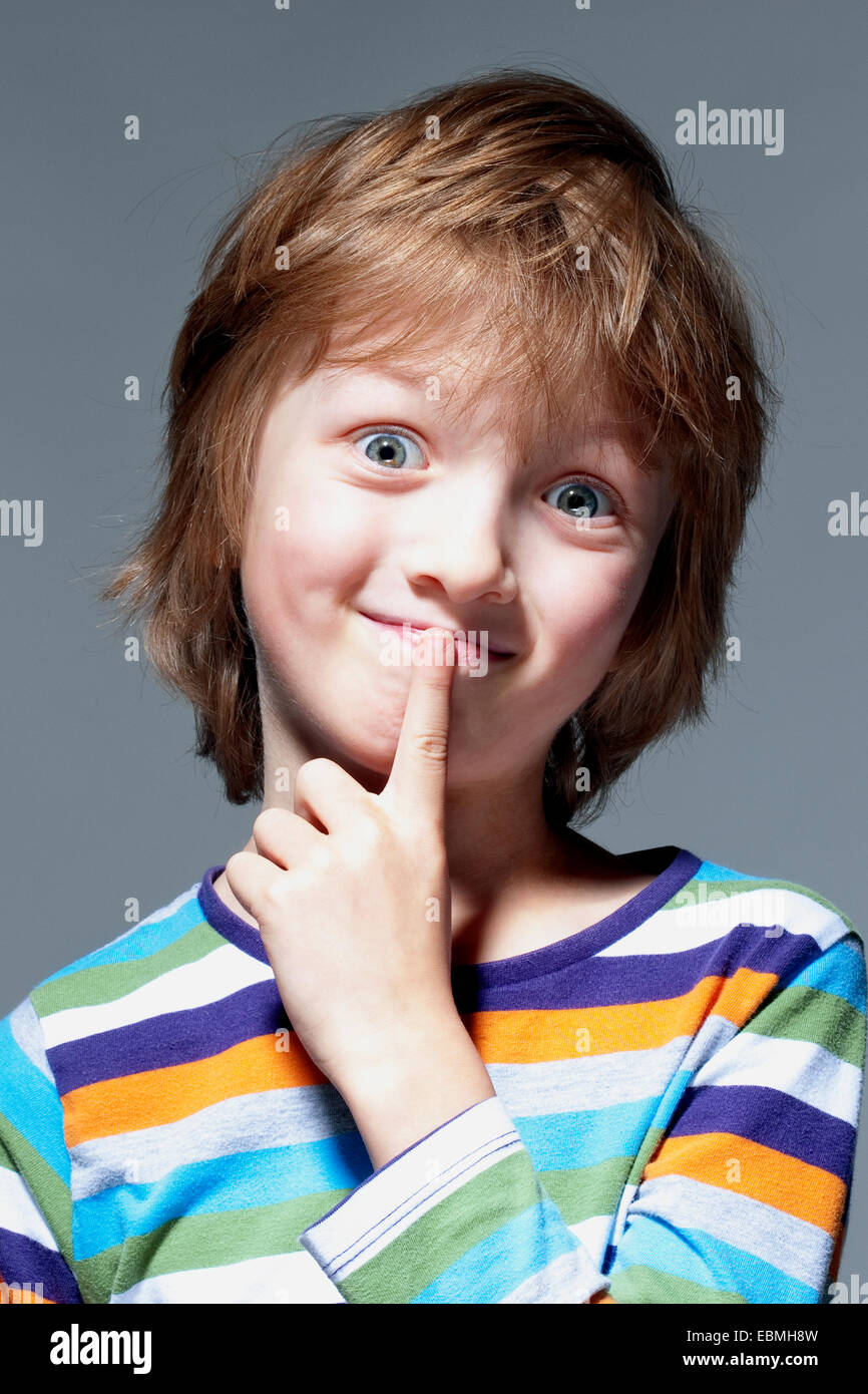 Boy Looking Thinking, Finger on his Mouth - Isolated on Gray Stock ...