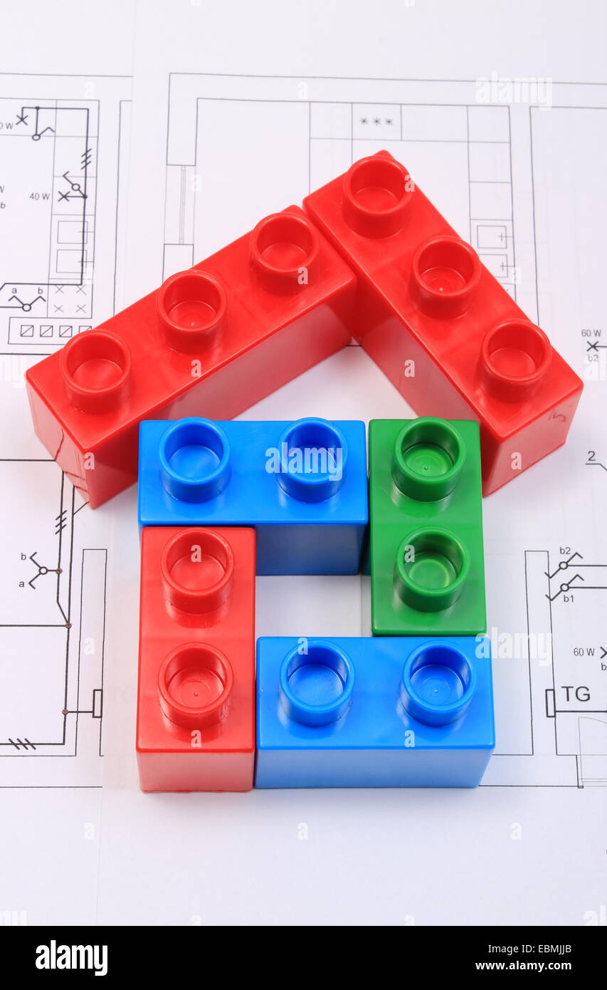 House shape of colorful plastic building blocks lying on construction ...