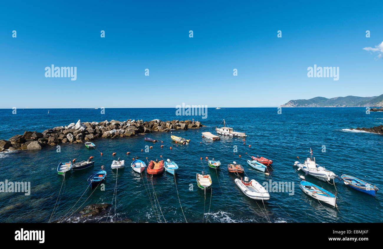Boats in the harbor in front of harbour protection wall, Riomaggiore ...