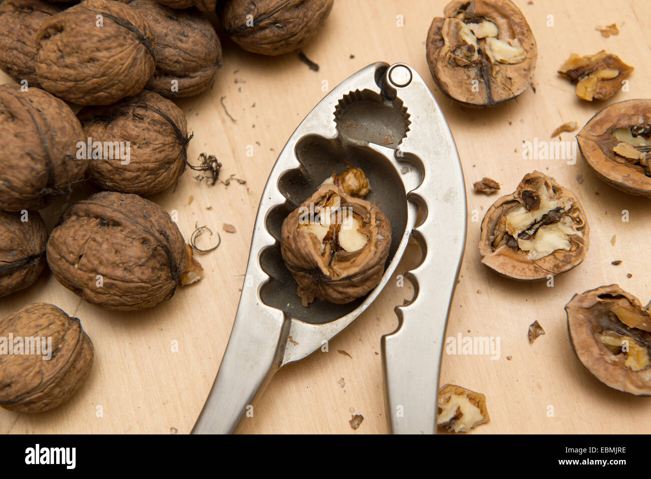walnuts and nutcracker on the wooden table Stock Photo - Alamy