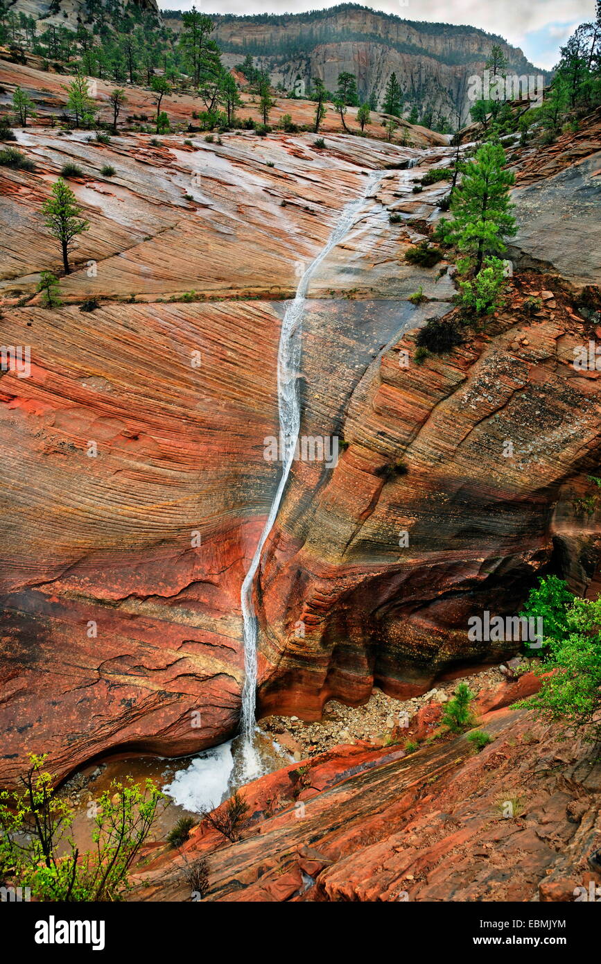 Water draining off over red Navajo sandstone rocks after a rainstorm ...