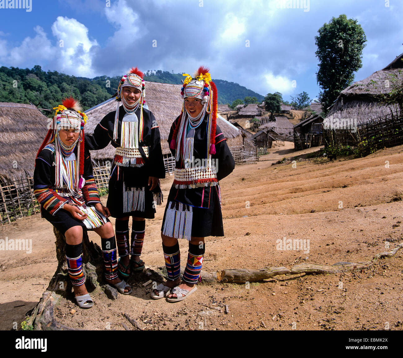 Three Akha girls in a mountain village, in traditional costume and ...