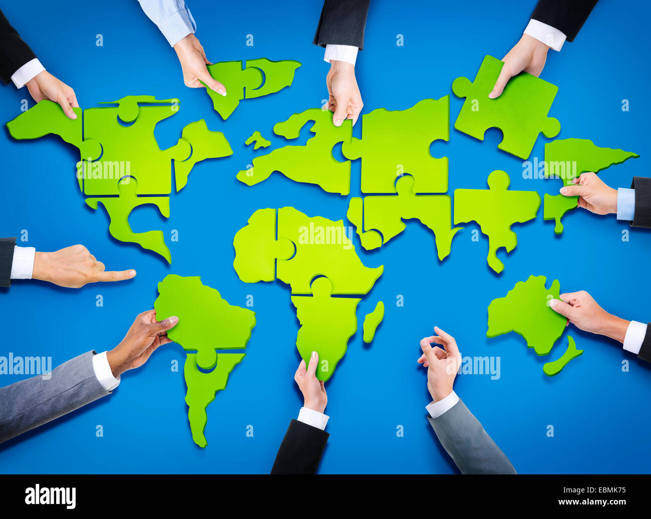 Group of Business People with Jigsaw Puzzle Forming in World Map Stock ...