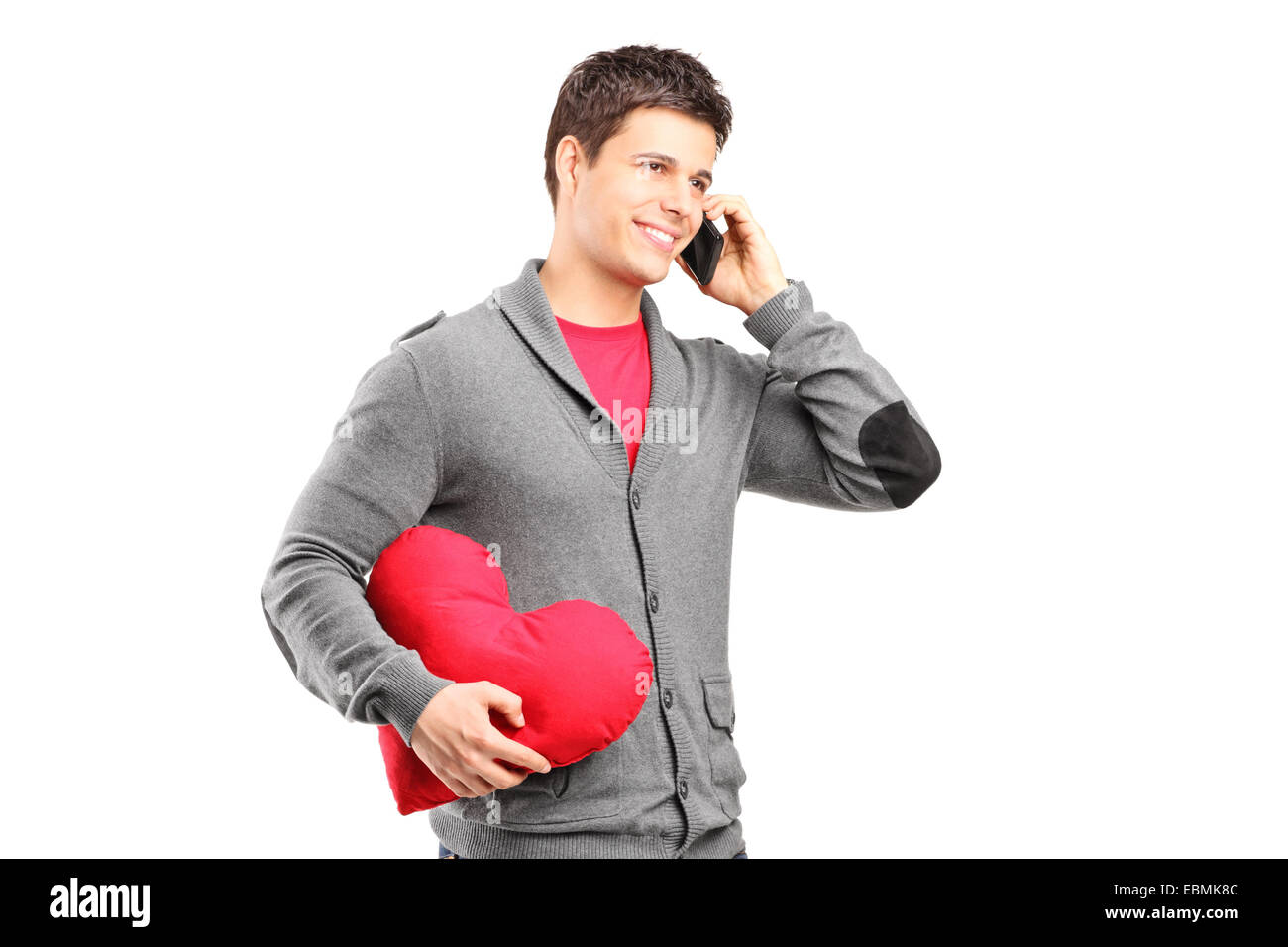 Man having a romantic conversation on the phone isolated on white ...
