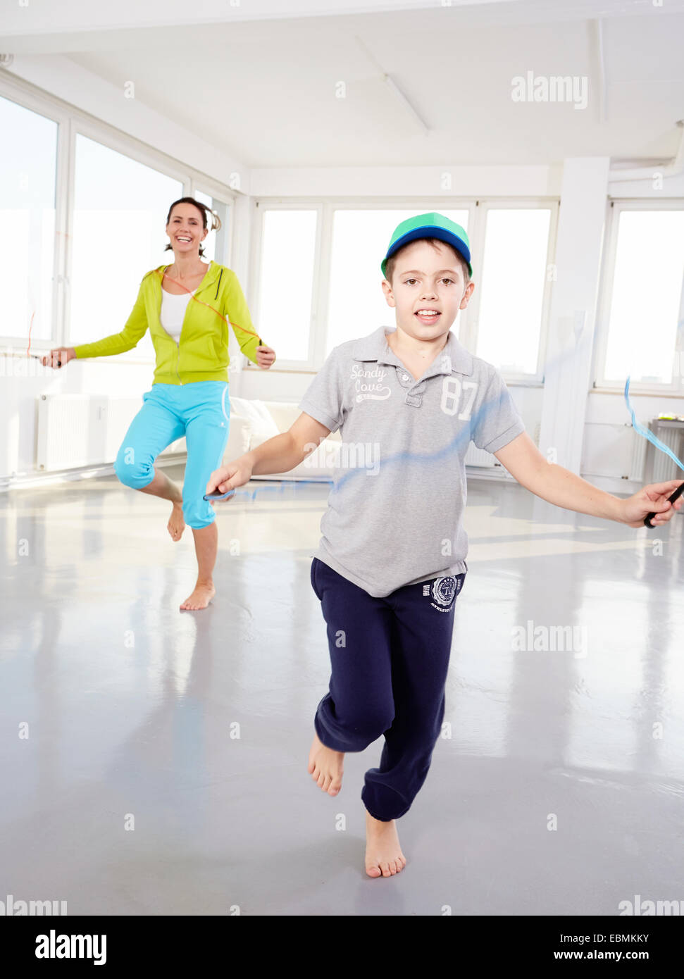 Mother and son skipping rope, Germany Stock Photo - Alamy