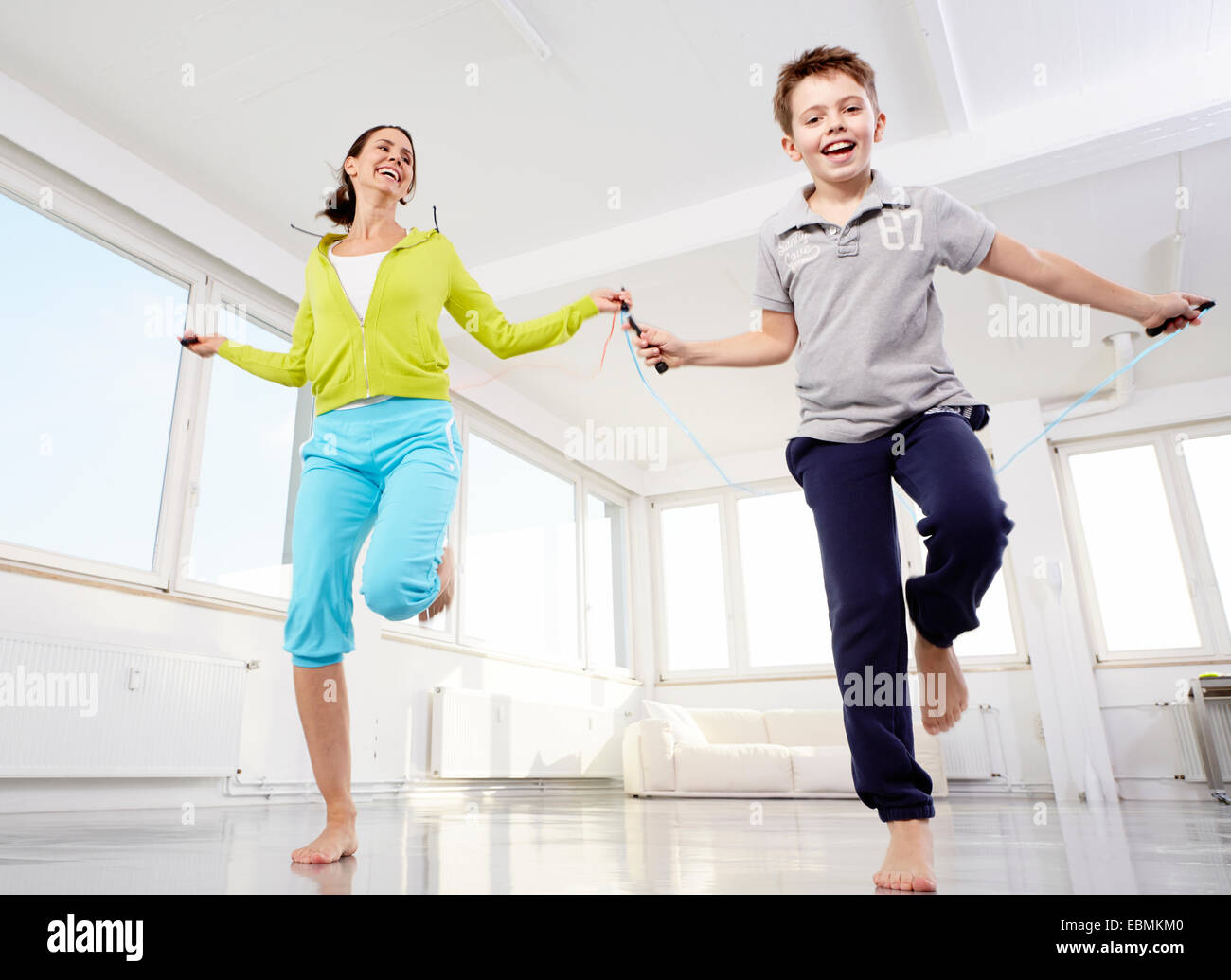 Mother and son skipping rope, Germany Stock Photo - Alamy