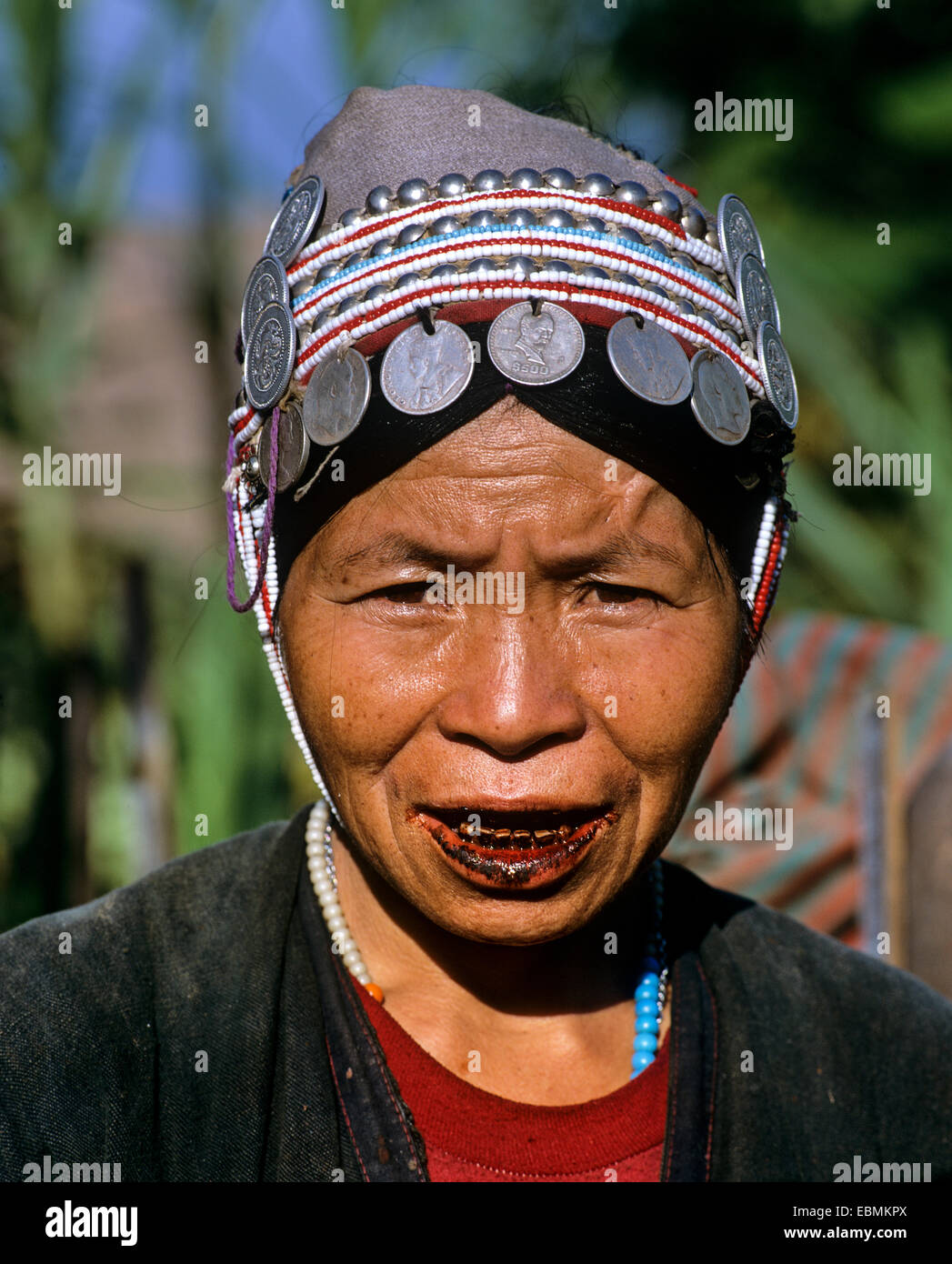 Akha woman with traditional clothing and headdress with Silbergmuenzen ...