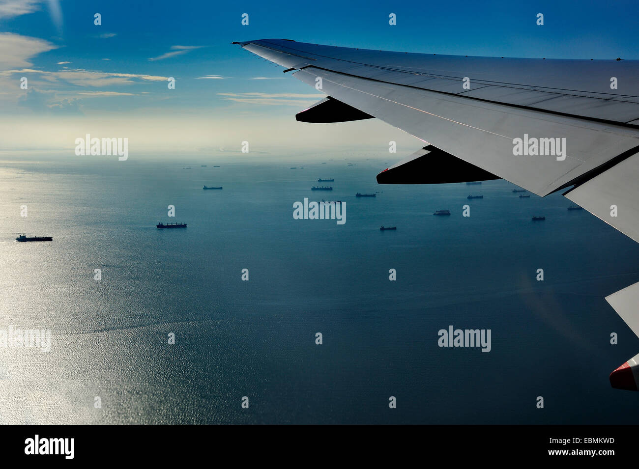 Wing of a plane with views of the port area of Jakarta on landing ...