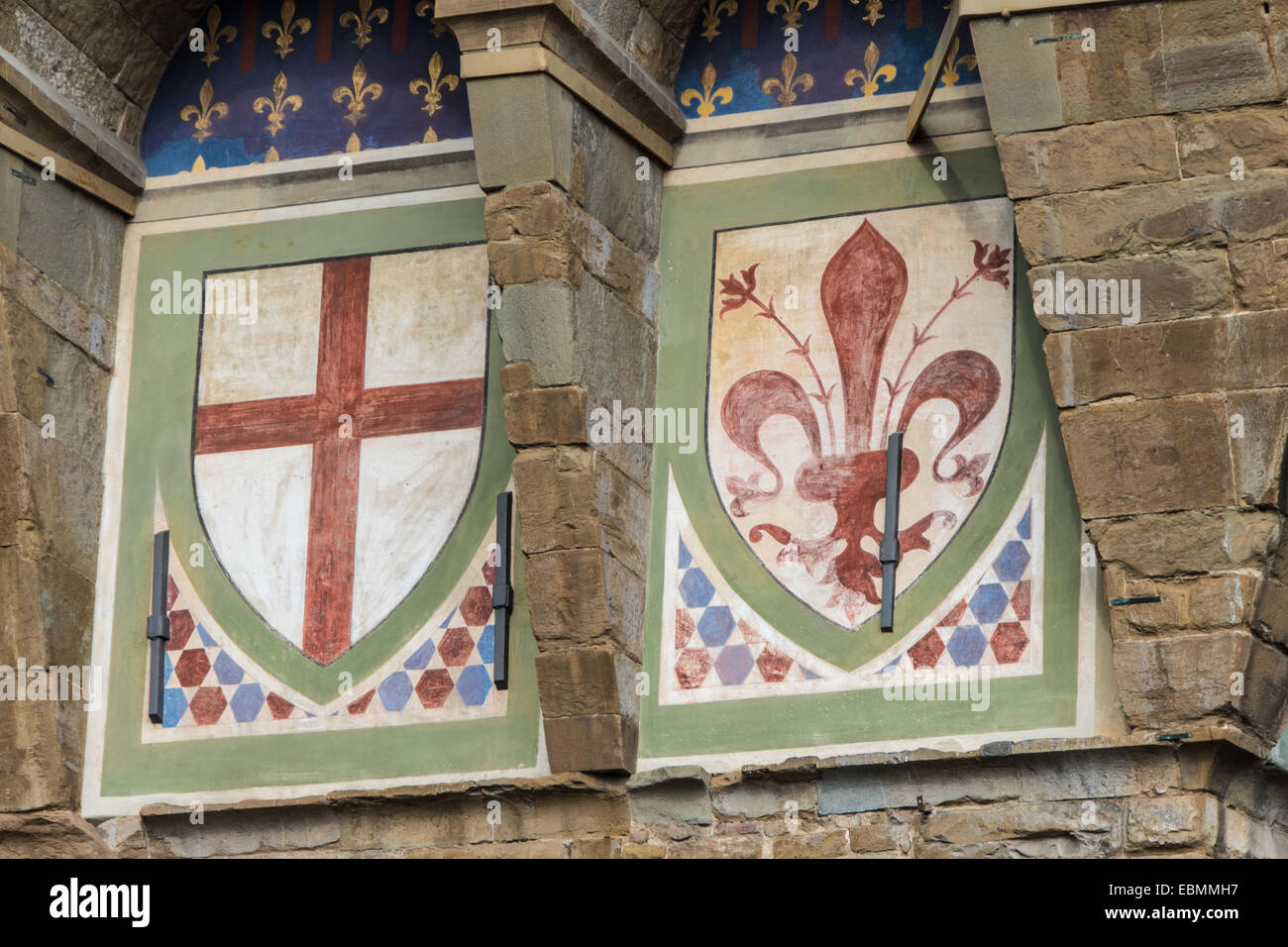 Detail of two emblems of the Florentine Republic on the facade of the ...