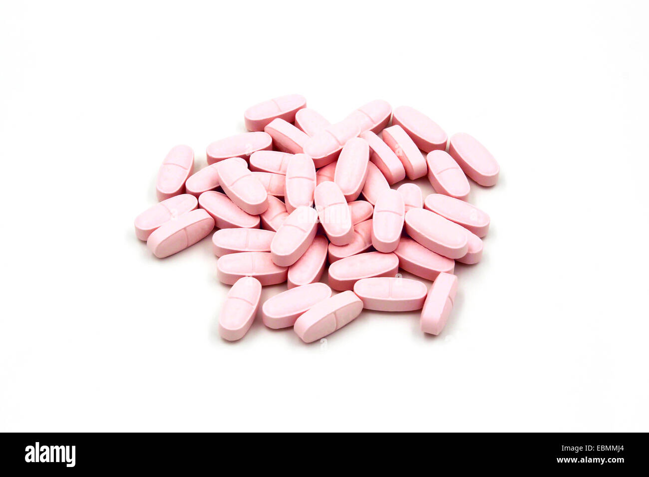 Pink pills on white background Stock Photo - Alamy