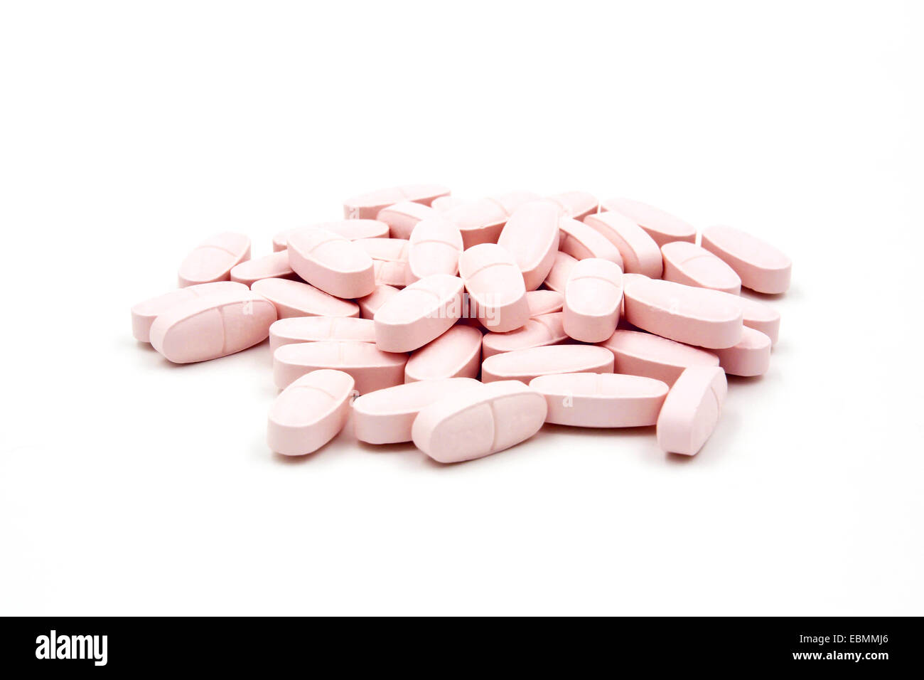 Pink pills on white background Stock Photo - Alamy