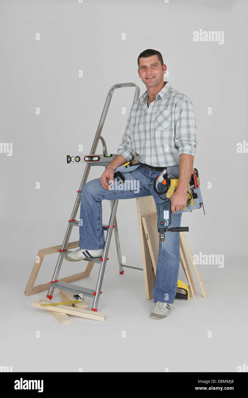 Tradesman posing with his building materials Stock Photo - Alamy