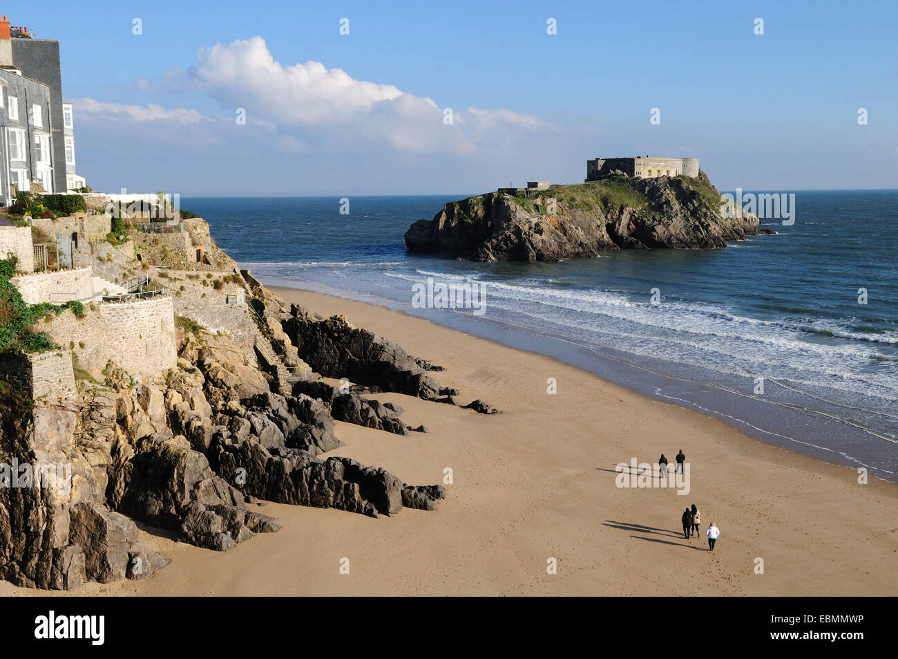People walking on Tenby South Beach in winter Pembrokeshire Wales Cymru ...