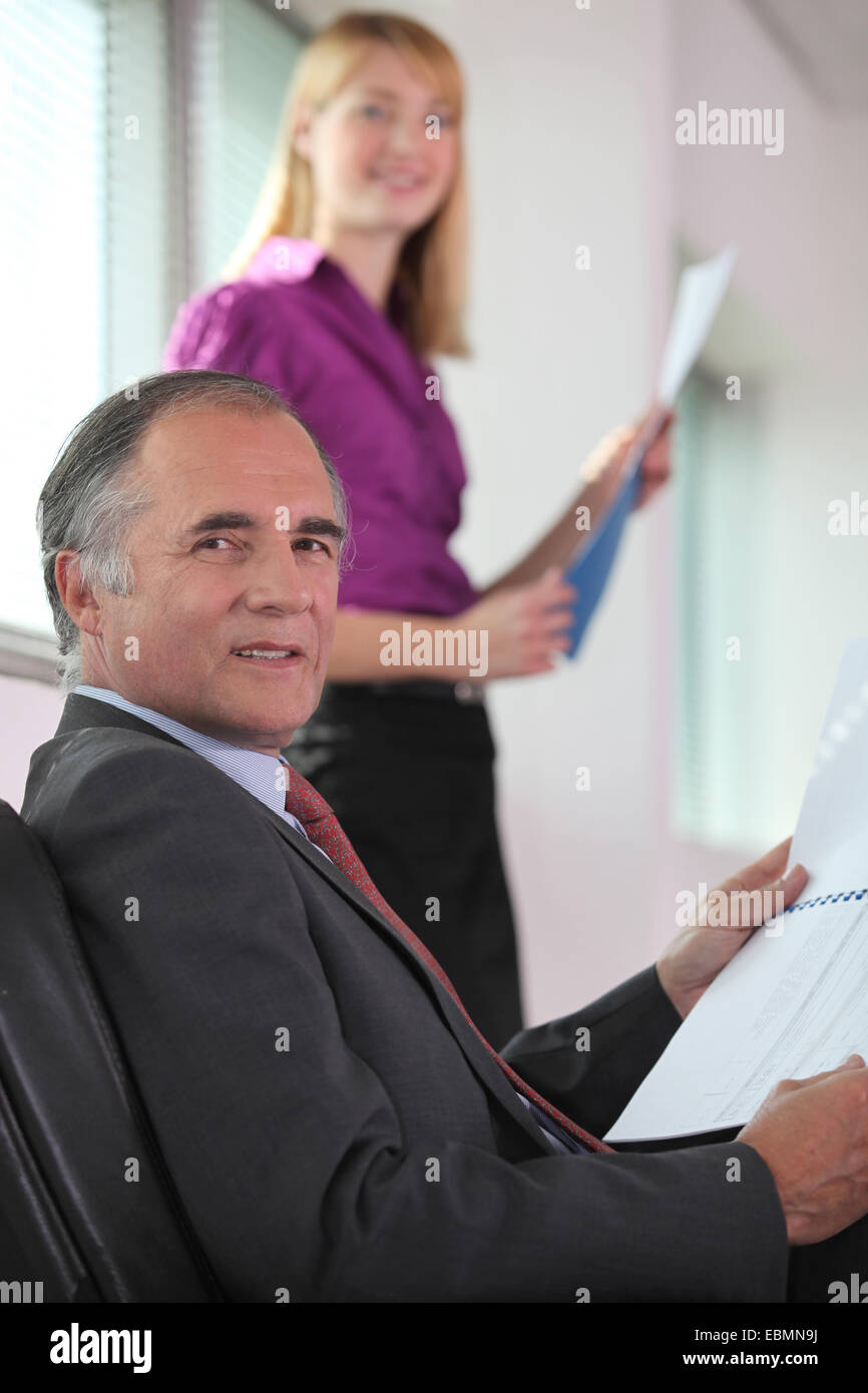 Boss running through presentation Stock Photo - Alamy