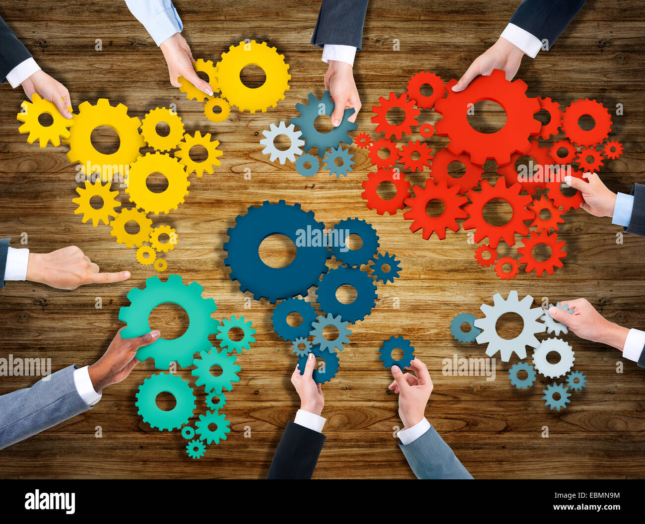 Group of Business People Holding Gears Stock Photo - Alamy