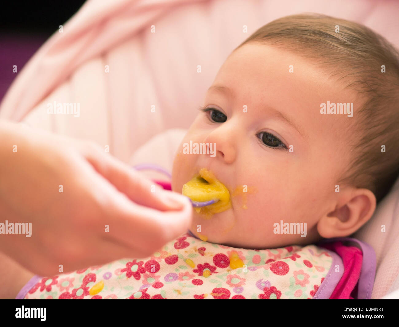 Mom feeding small baby girl in basket Stock Photo - Alamy