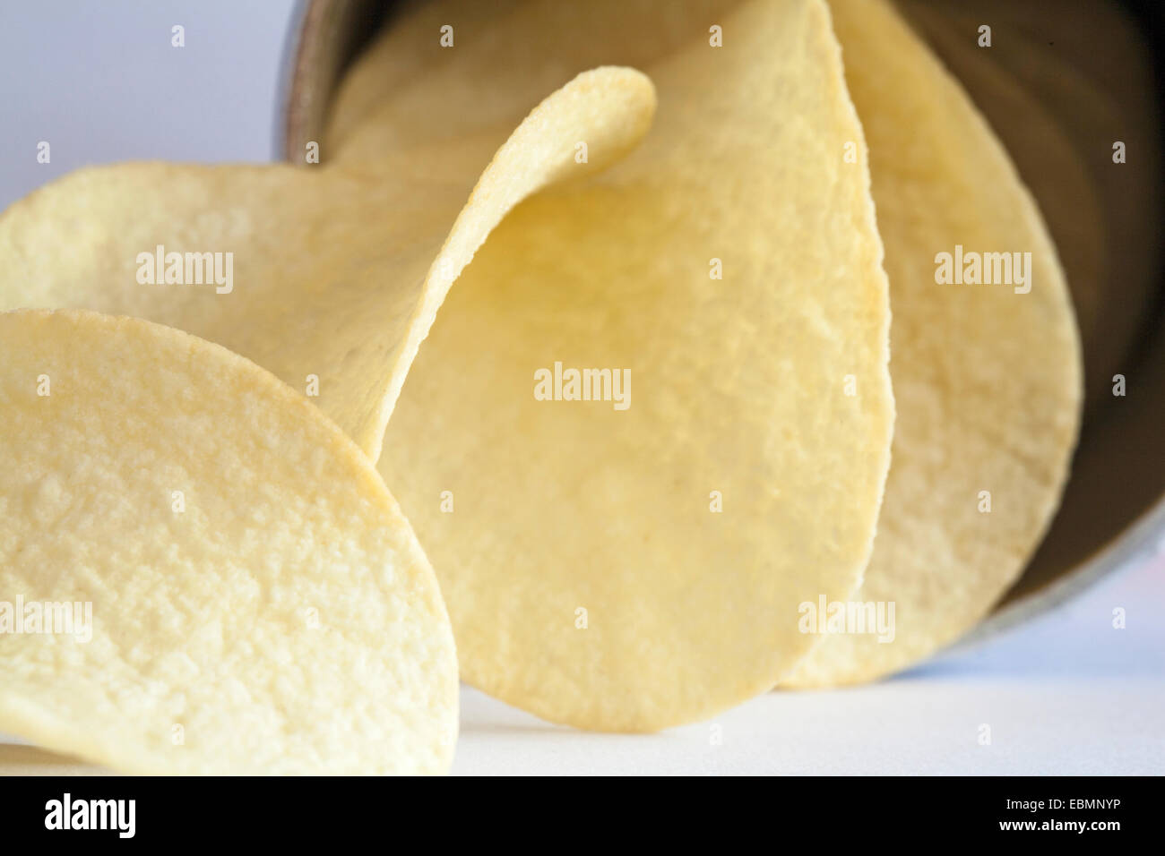 open tub of Pringles Original with contents spilled on white background ...
