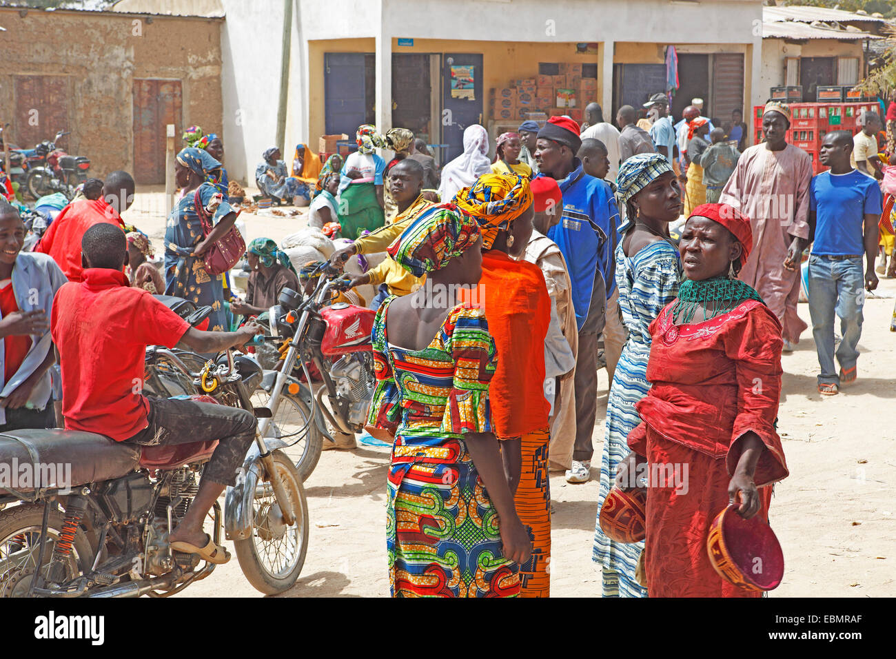 Woman selling typical gourd helmets at a market, Tourou, Far North ...