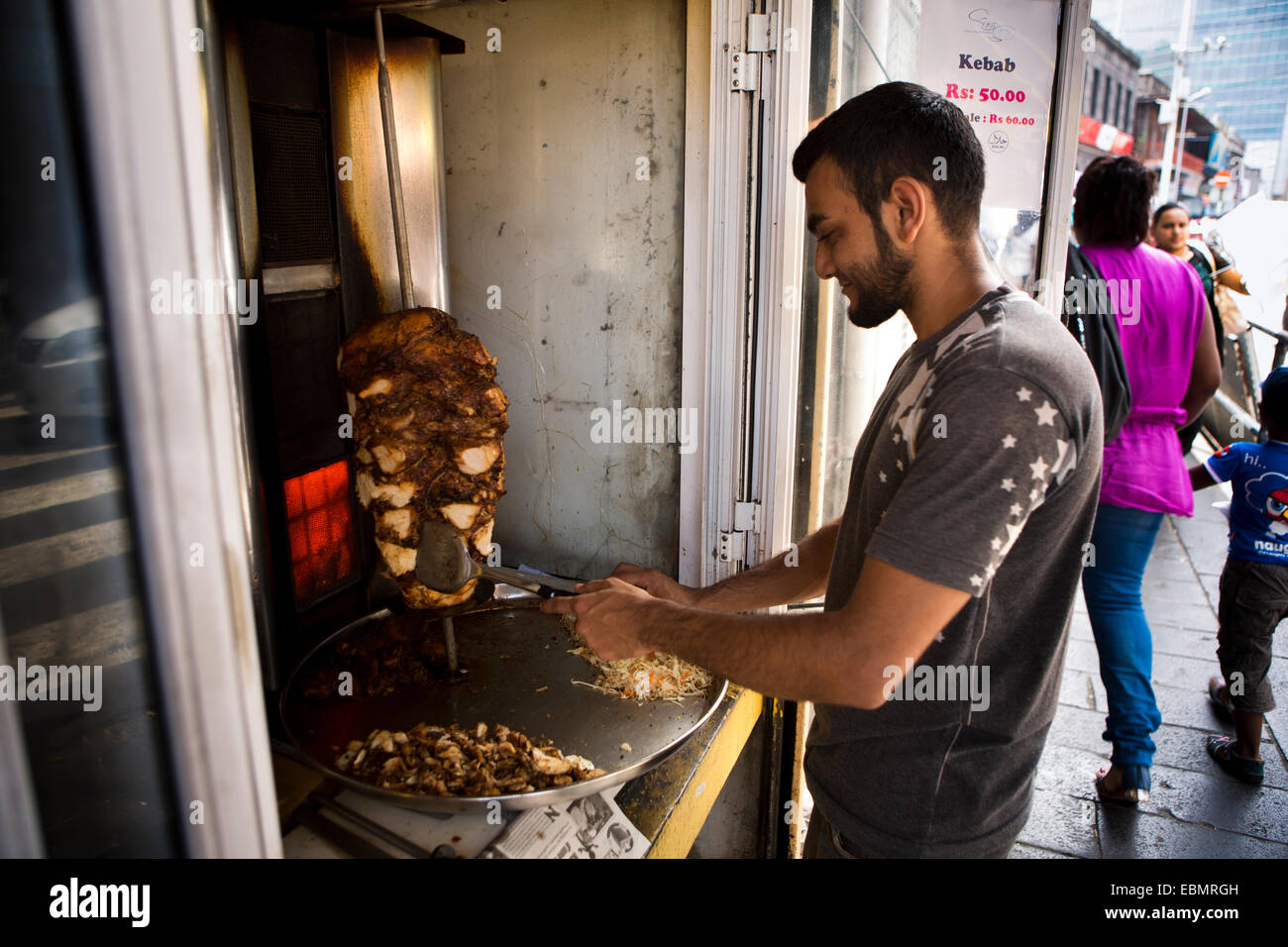 Mauritius, Port Louis, Place Victoria Square, man cooking chicken kebab ...