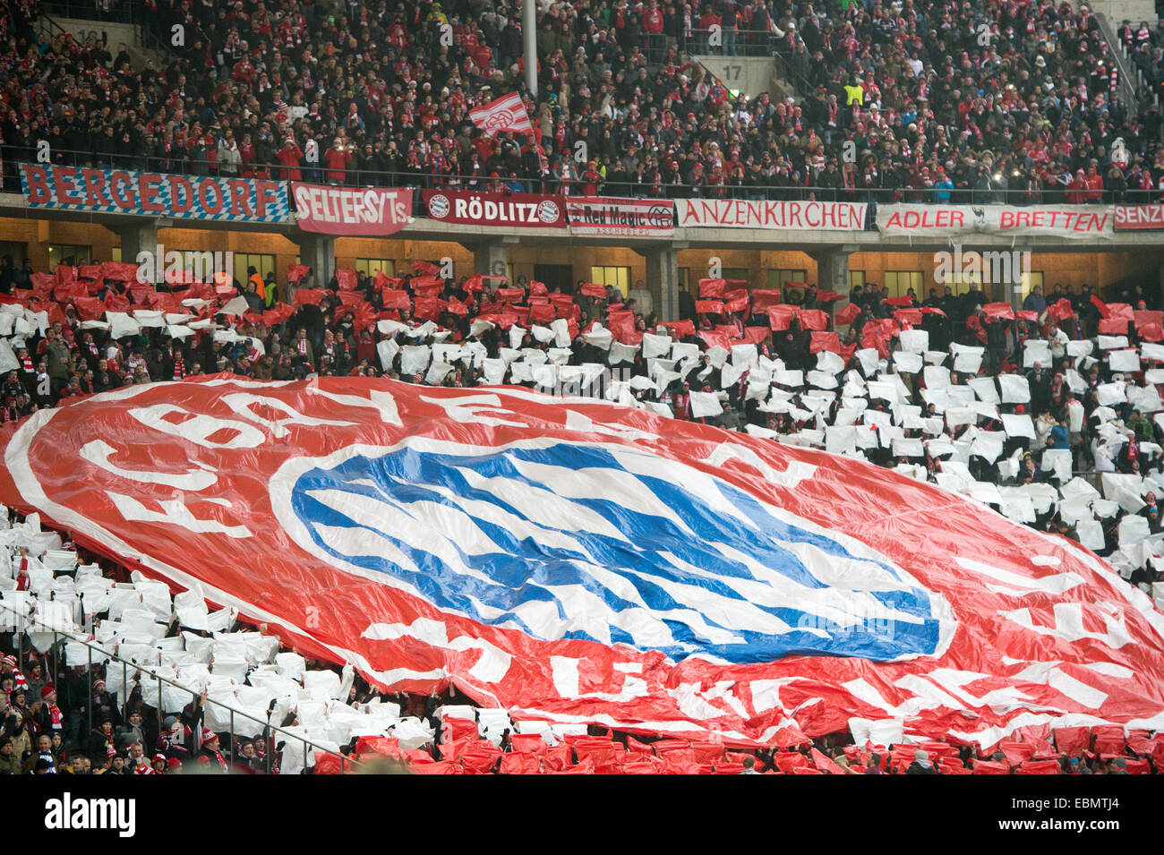 Bayern Munich fans cheer and present a banner showing the logo of FC ...