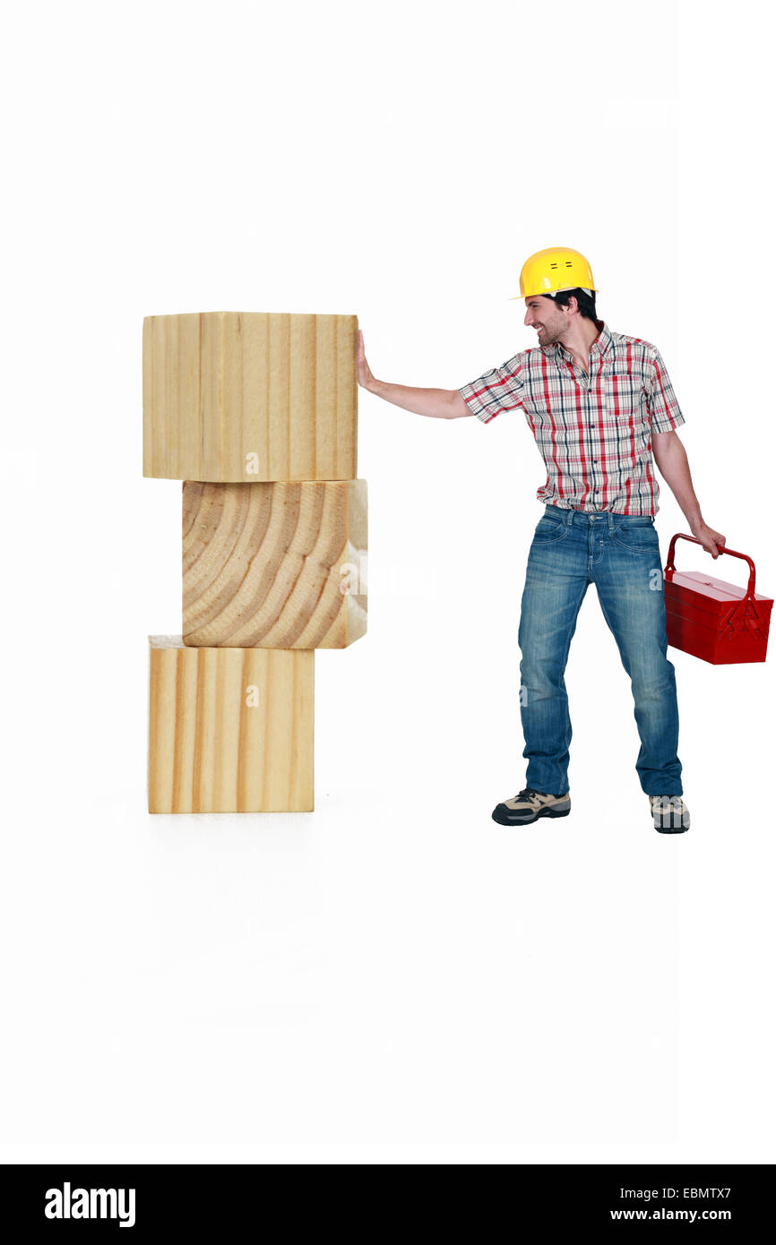 Worker pushing wood Stock Photo - Alamy