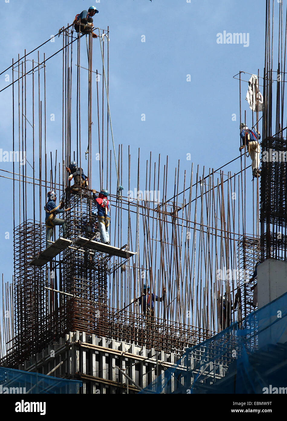 Quezon City, Philippines. 3rd Dec, 2014. Laborers work at a ...