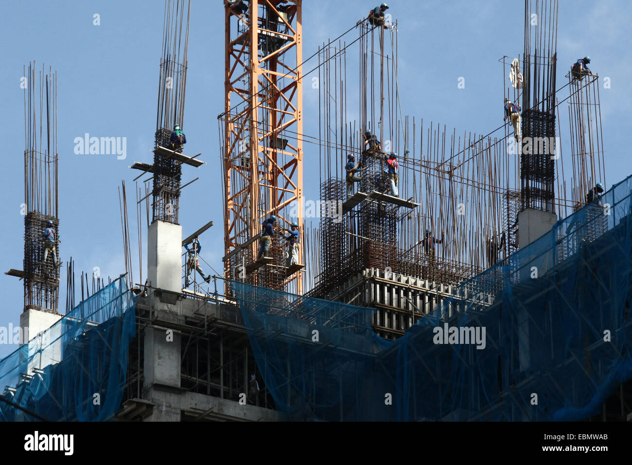 Quezon City, Philippines. 3rd Dec, 2014. Laborers work at a ...