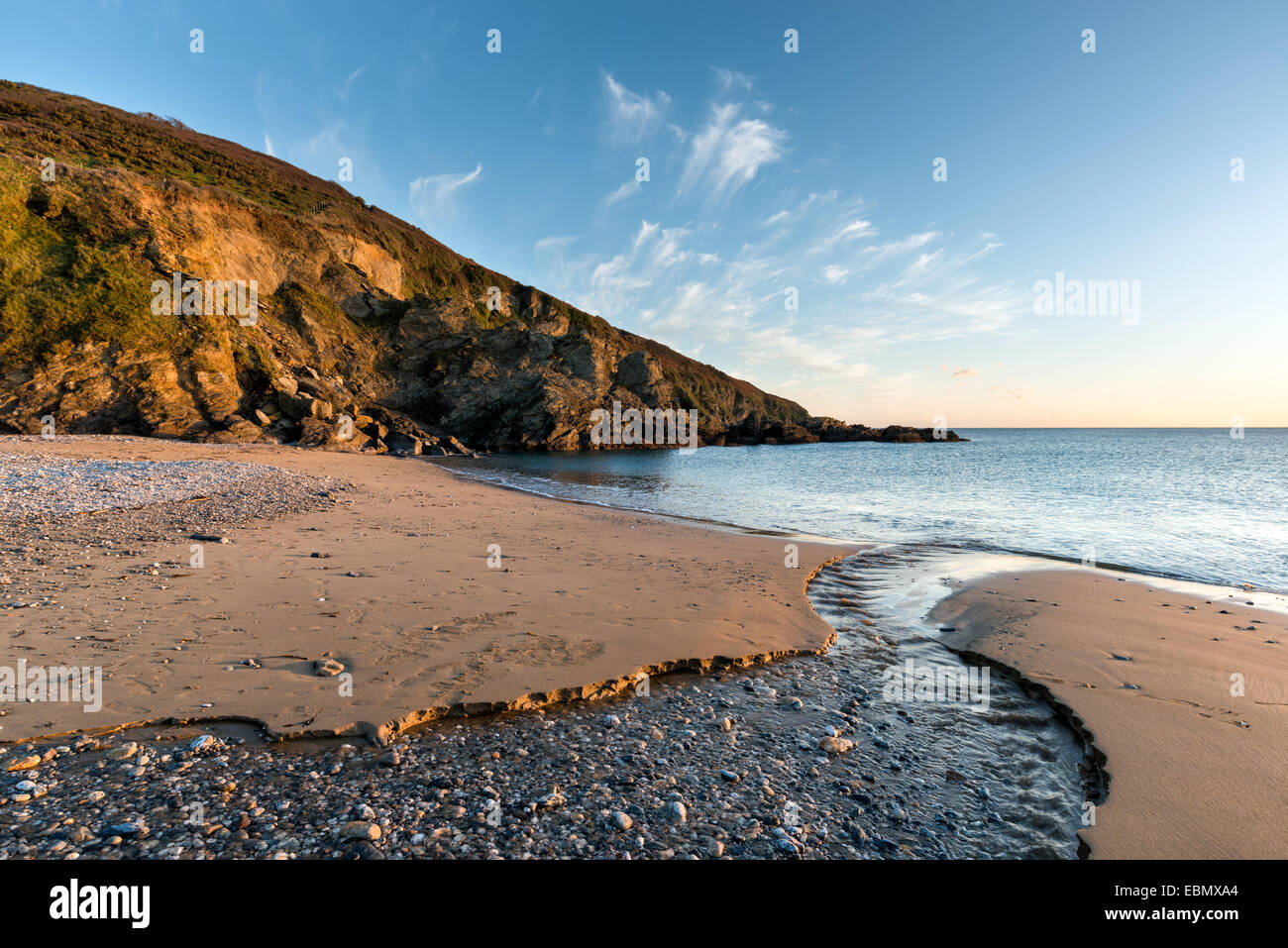 A stream flowing in to the sea at Hemmick beach near Gorran in Cornwall ...