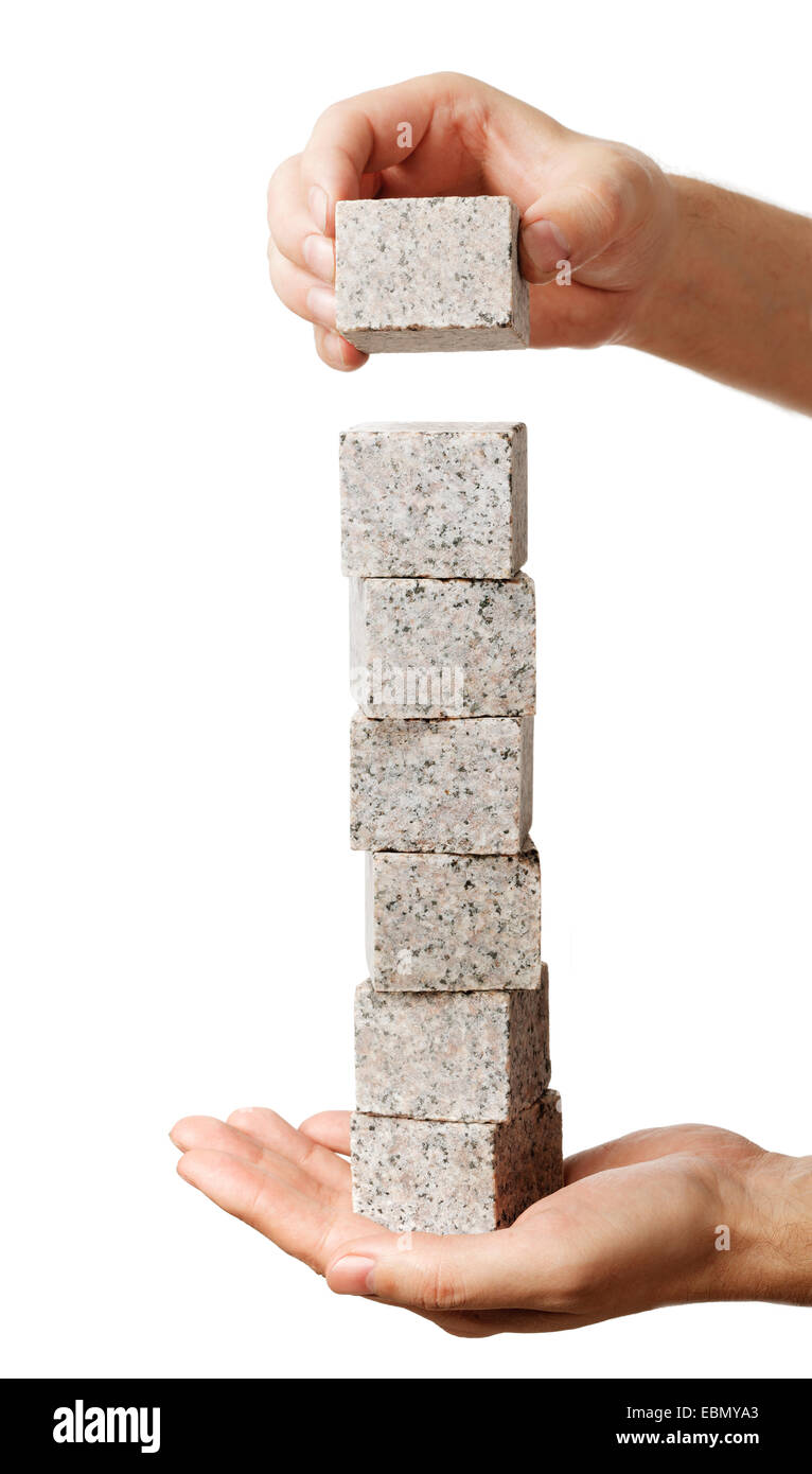 Man stacking granite rock blocks in his hand Stock Photo - Alamy