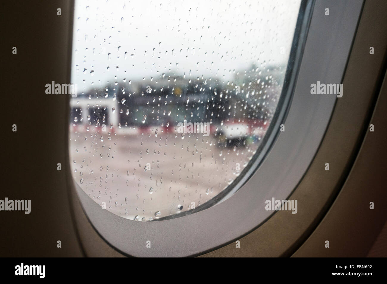 Looking out of an Airbus A321 window covered in raindrops at East ...
