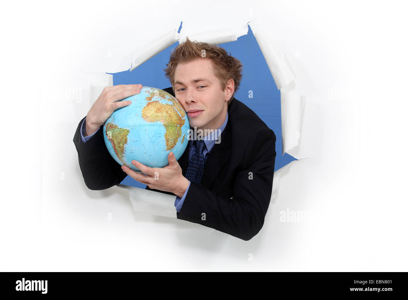 Businessman hugging globe Stock Photo - Alamy