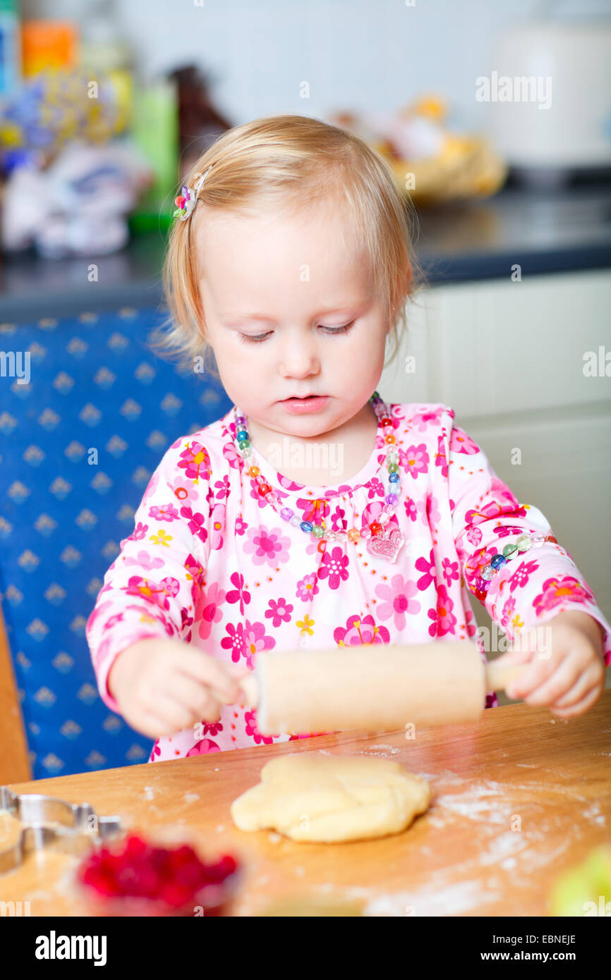 little girl rolling out dough with a rolling pin Stock Photo - Alamy