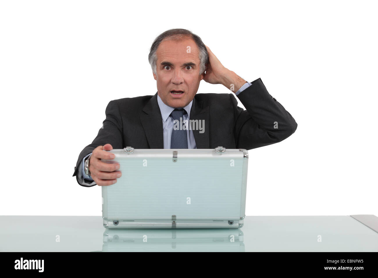 Shocked man looking in an aluminium briefcase Stock Photo - Alamy