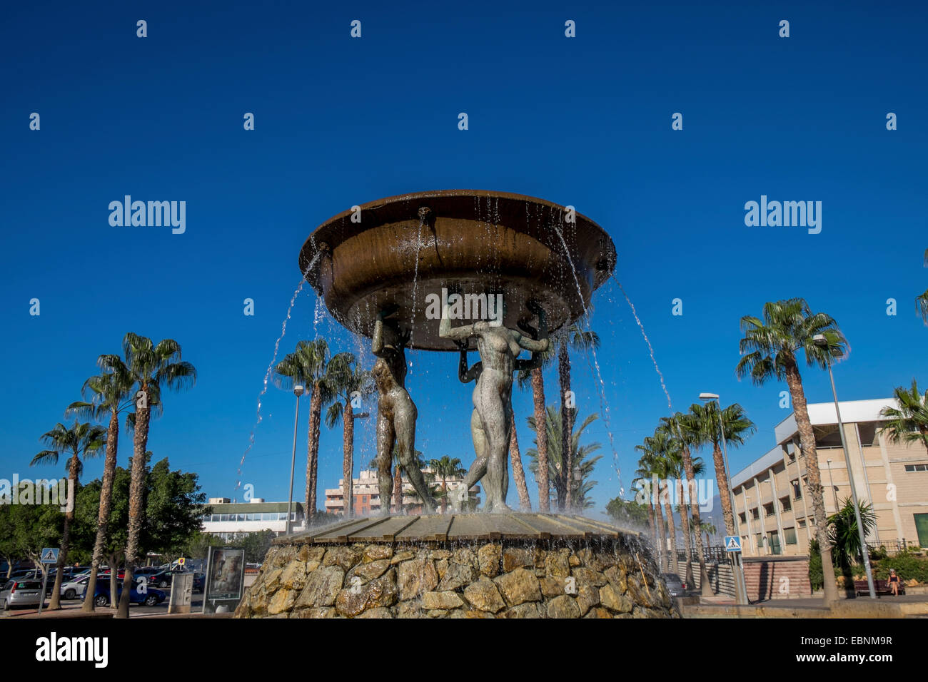 Three nymphs in a water fountain holding a large dish with the water ...