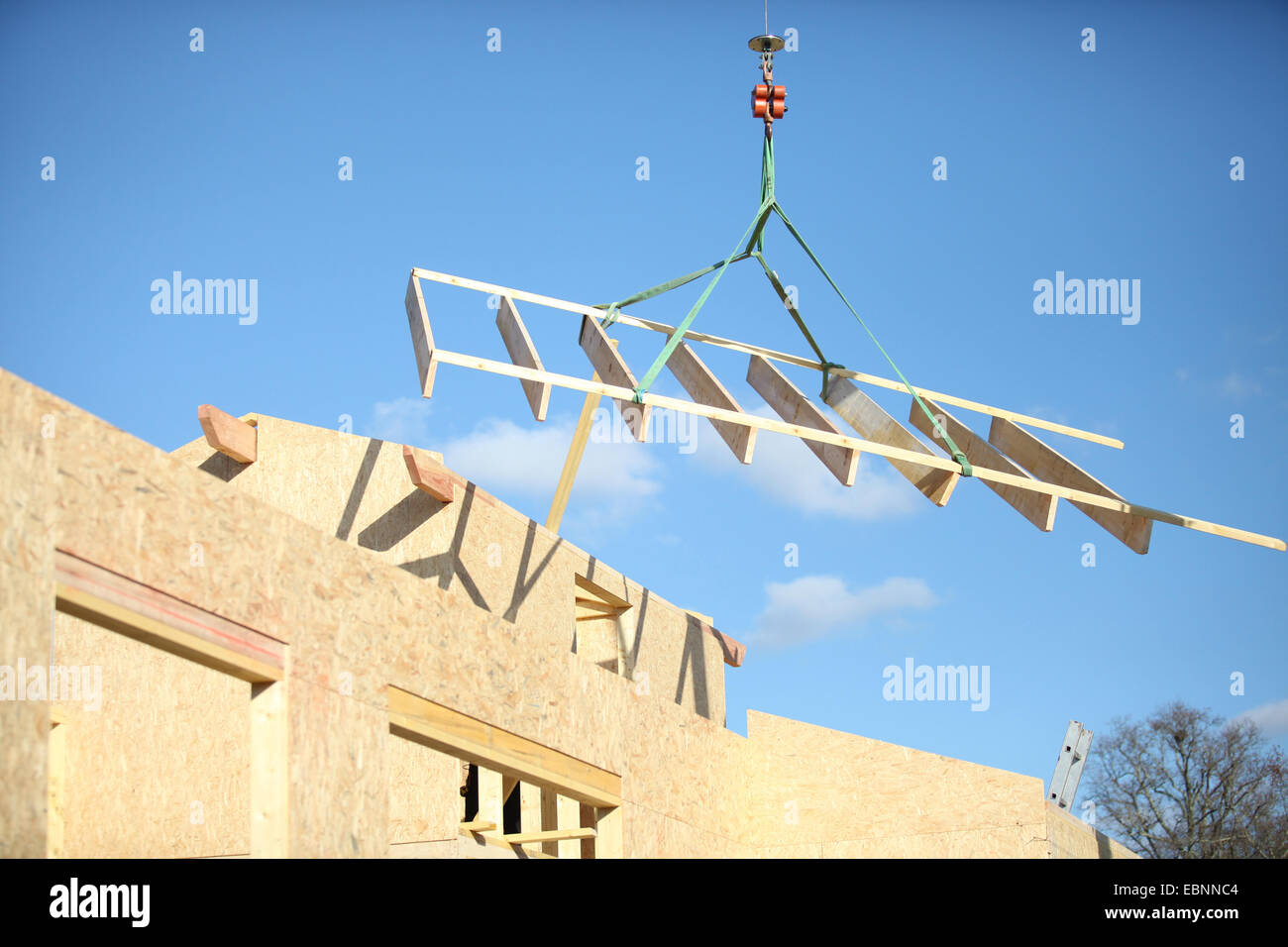 A crane lifting a wood structure Stock Photo - Alamy