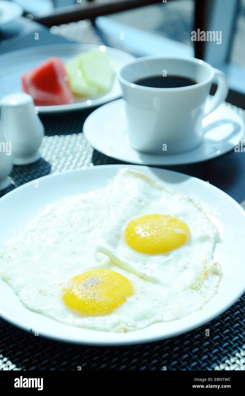 Morning breakfast, sunny side up eggs with background a several slice ...