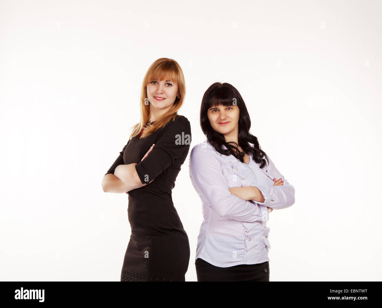 two young beautiful business women standing smiling Stock Photo - Alamy