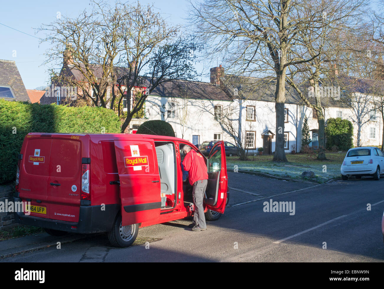 Royal Mail van and postman delivering at Shincliffe village, County ...