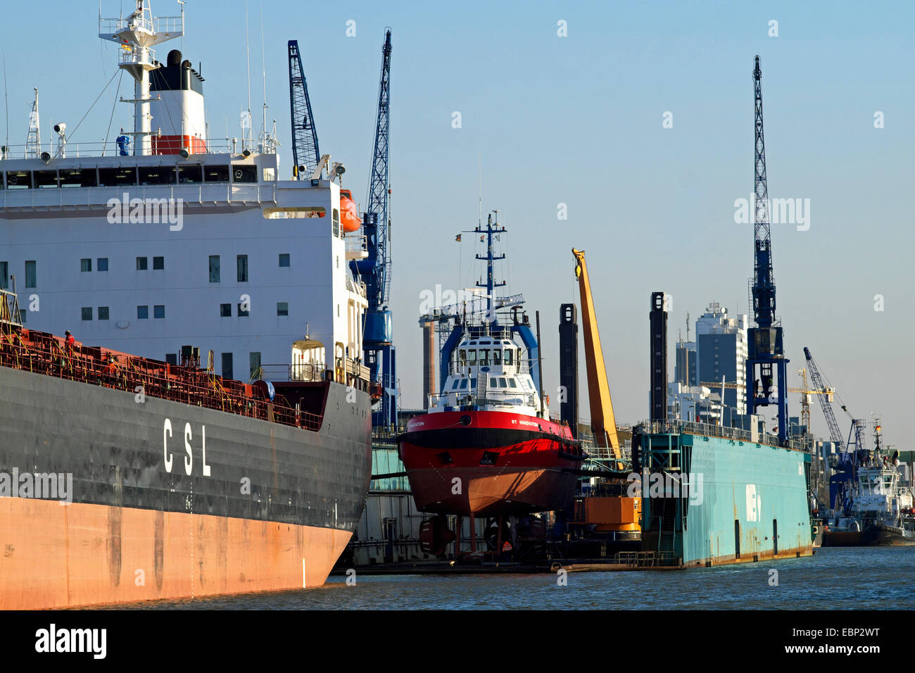 cargo ships in harbour and tugboat in floating dock, Germany ...